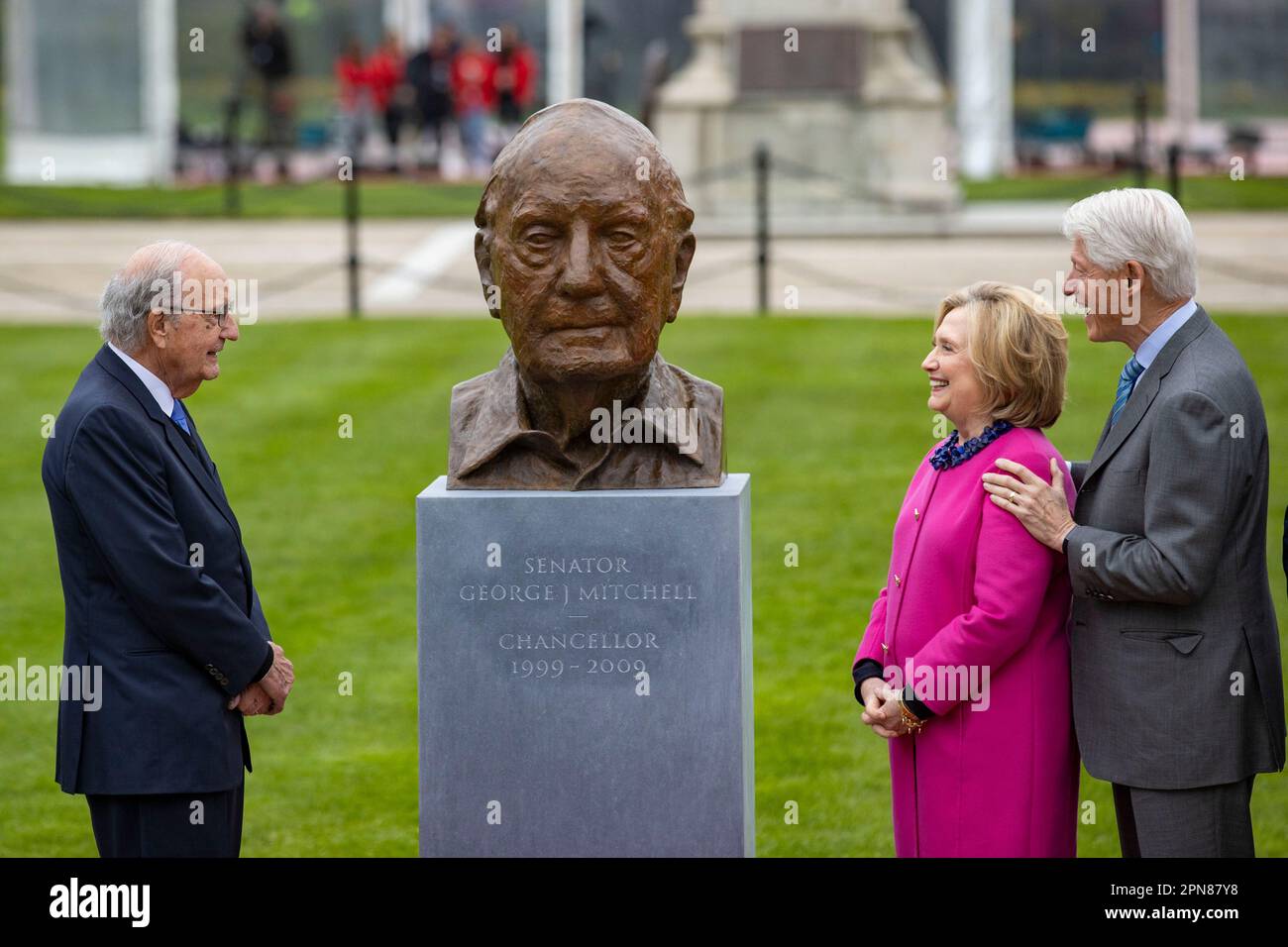 Senator George Mitchell (left) with former US president Bill Clinton (right) and his wife ...