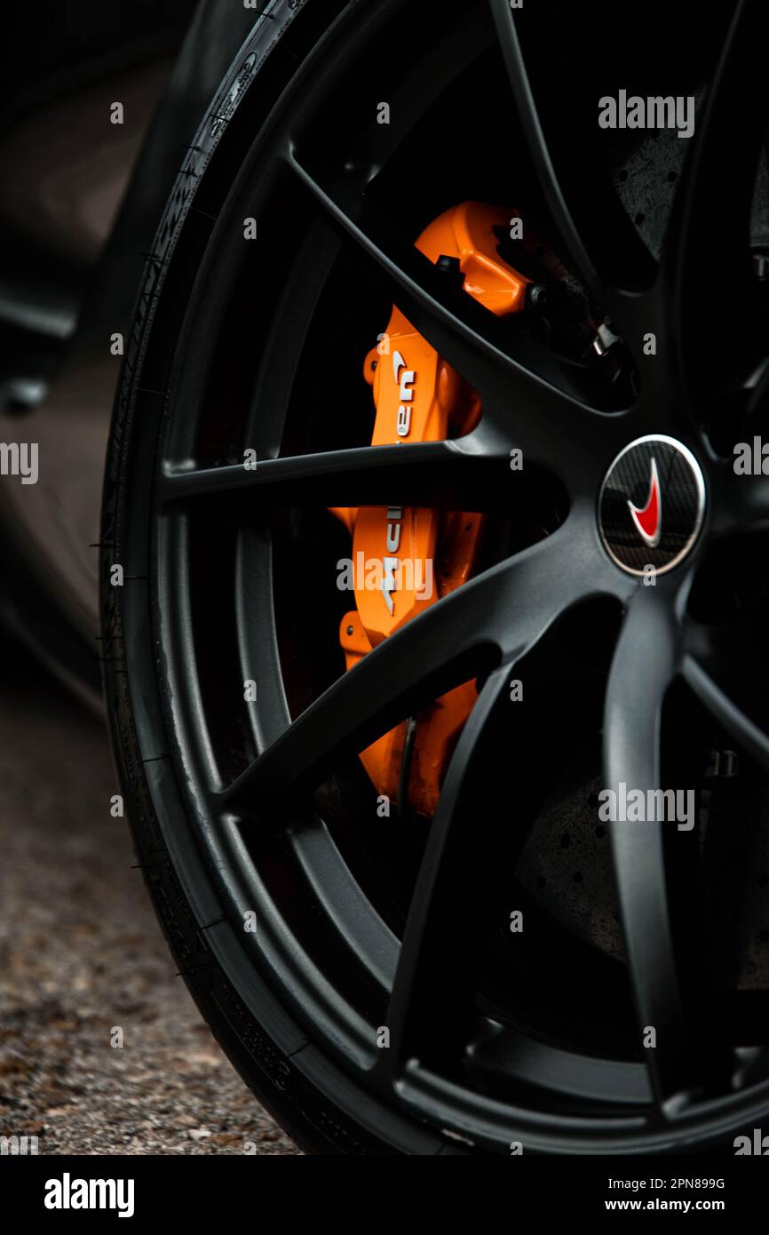 A vertical shot of the stylish rims of a luxurious black McLaren ...