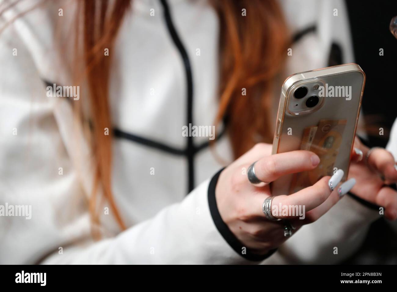 Female hand with smartphones close up. A young woman using mobile phone ...