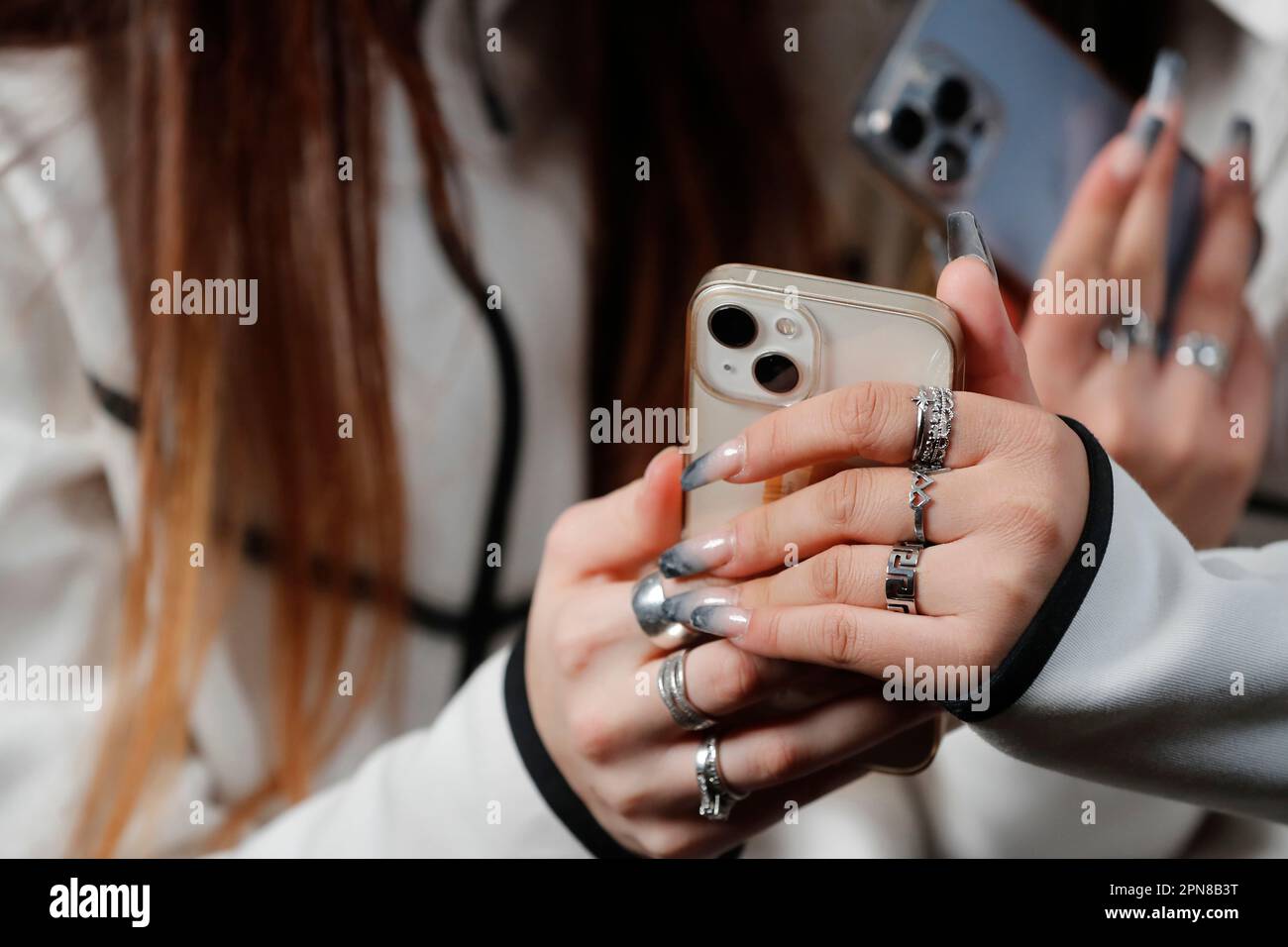 Two women using mobile phones hi-res stock photography and images - Alamy