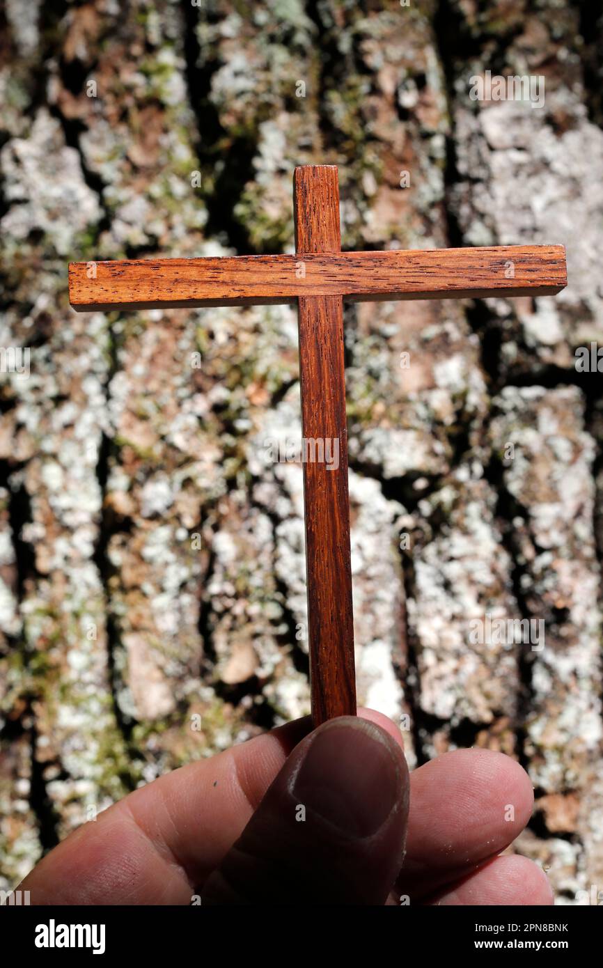 Christian wooden cross in hand. Faith and spirituality concept. France ...