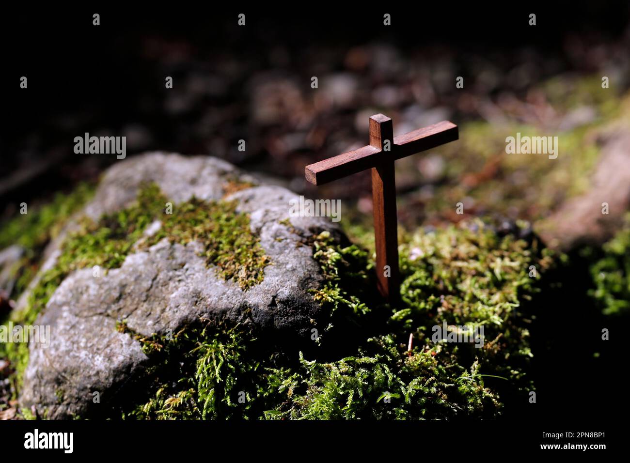 Christian cross on an old stone with moss. France Stock Photo - Alamy