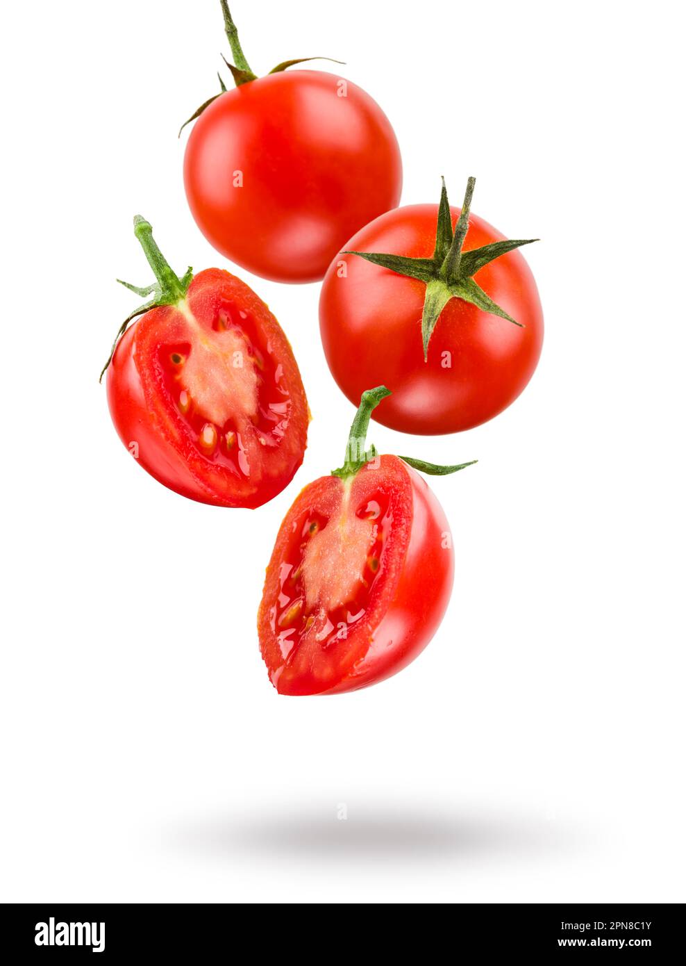 Small red cherry tomatoes floating on white background Stock Photo - Alamy