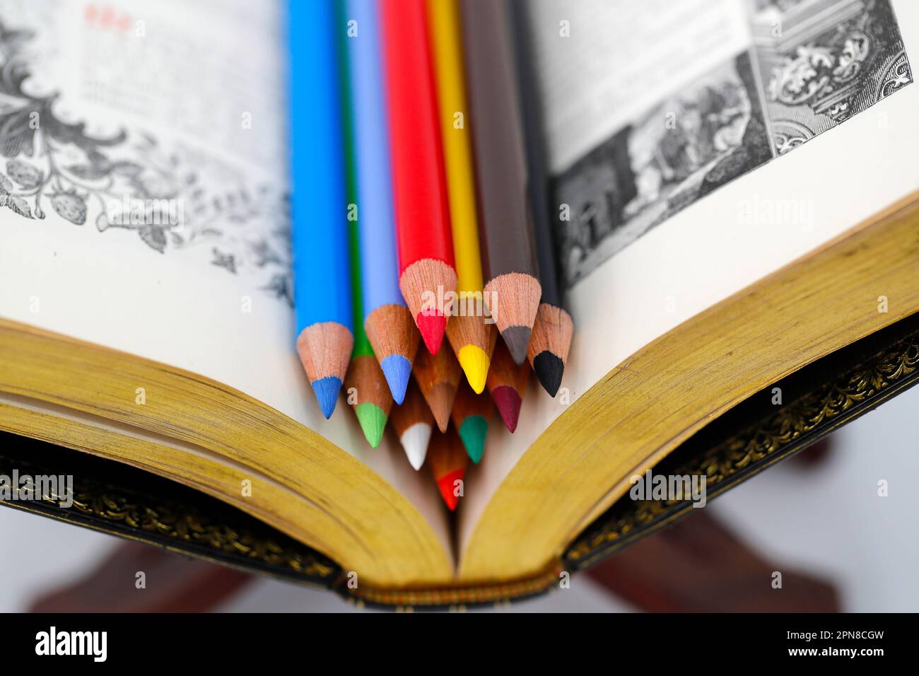 Colored pencils on a bible. Catechism. Christian curch Stock Photo - Alamy