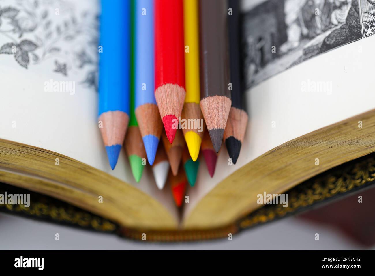 Colored pencils on a bible. Catechism. Christian curch Stock Photo - Alamy