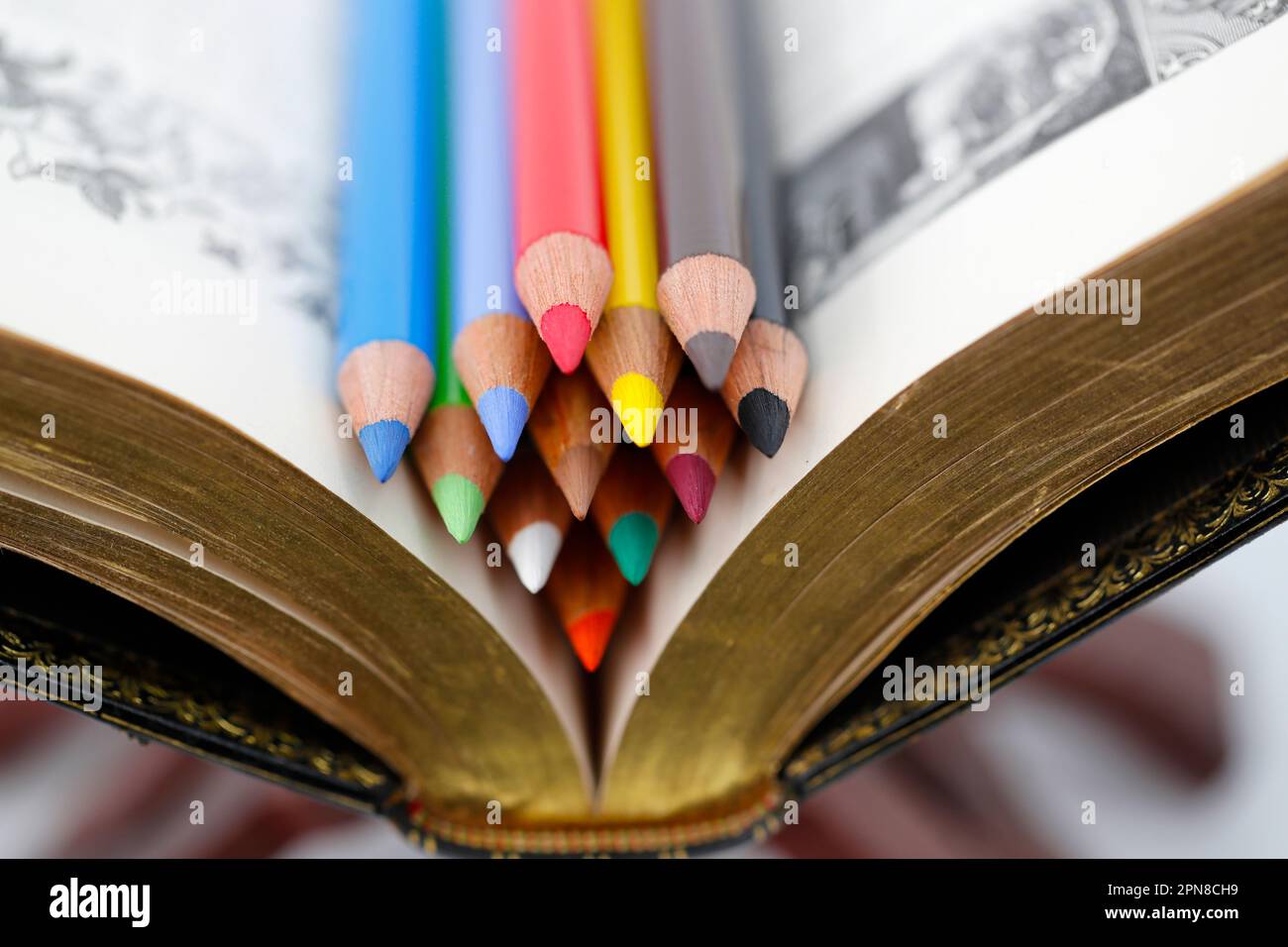 Colored pencils on a bible. Catechism. Christian curch Stock Photo - Alamy