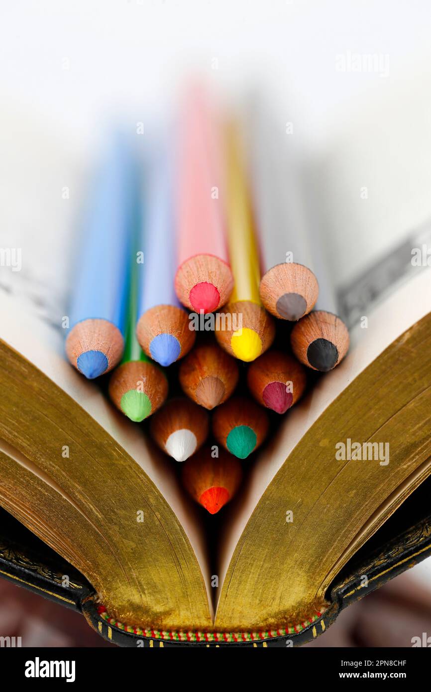 Colored pencils on a bible. Catechism. Christian curch Stock Photo - Alamy
