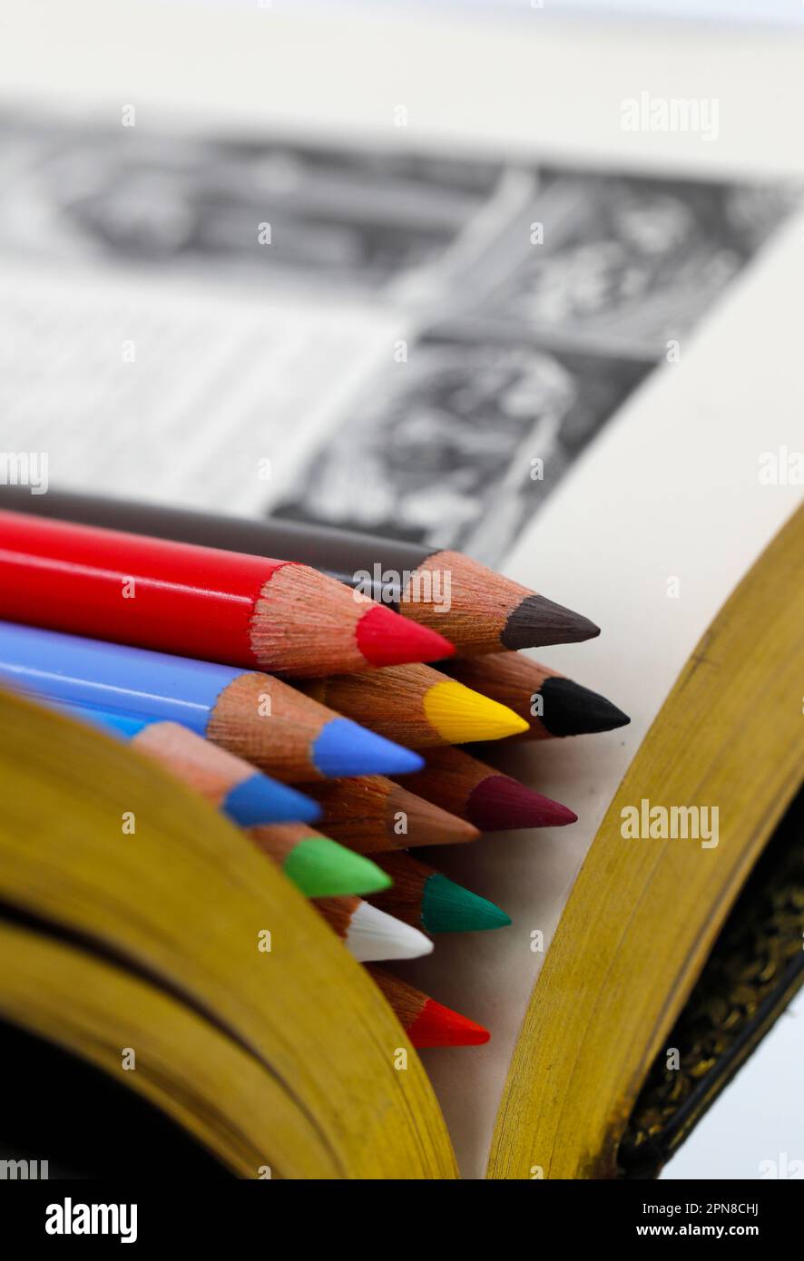 Colored pencils on a bible. Catechism. Christian curch Stock Photo - Alamy