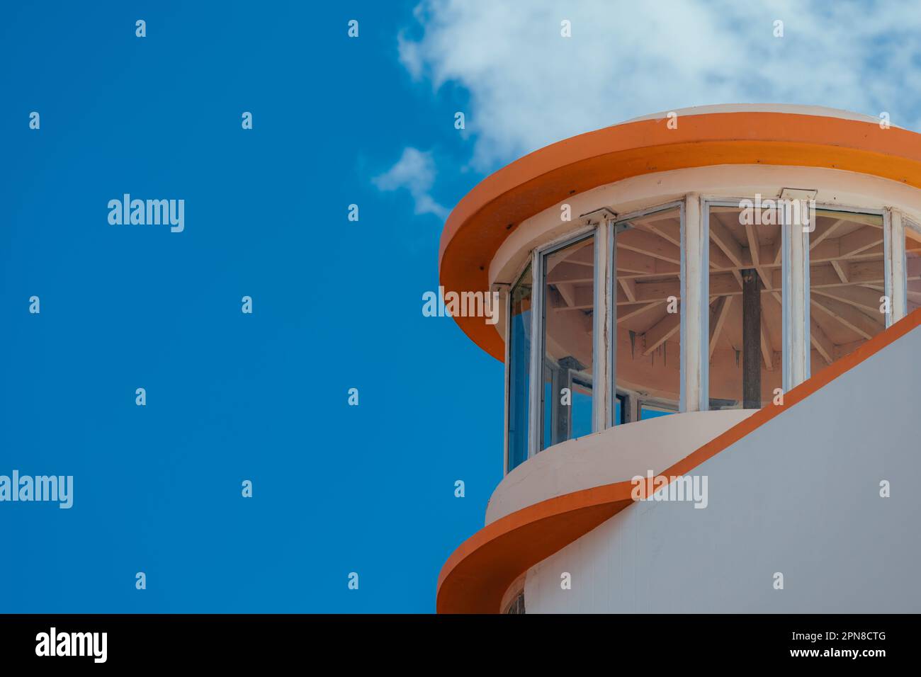 A majestic white high-rise building towers against a vivid blue sky ...