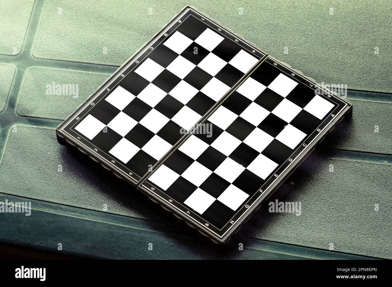 Empty chess board on green on the table Stock Photo - Alamy