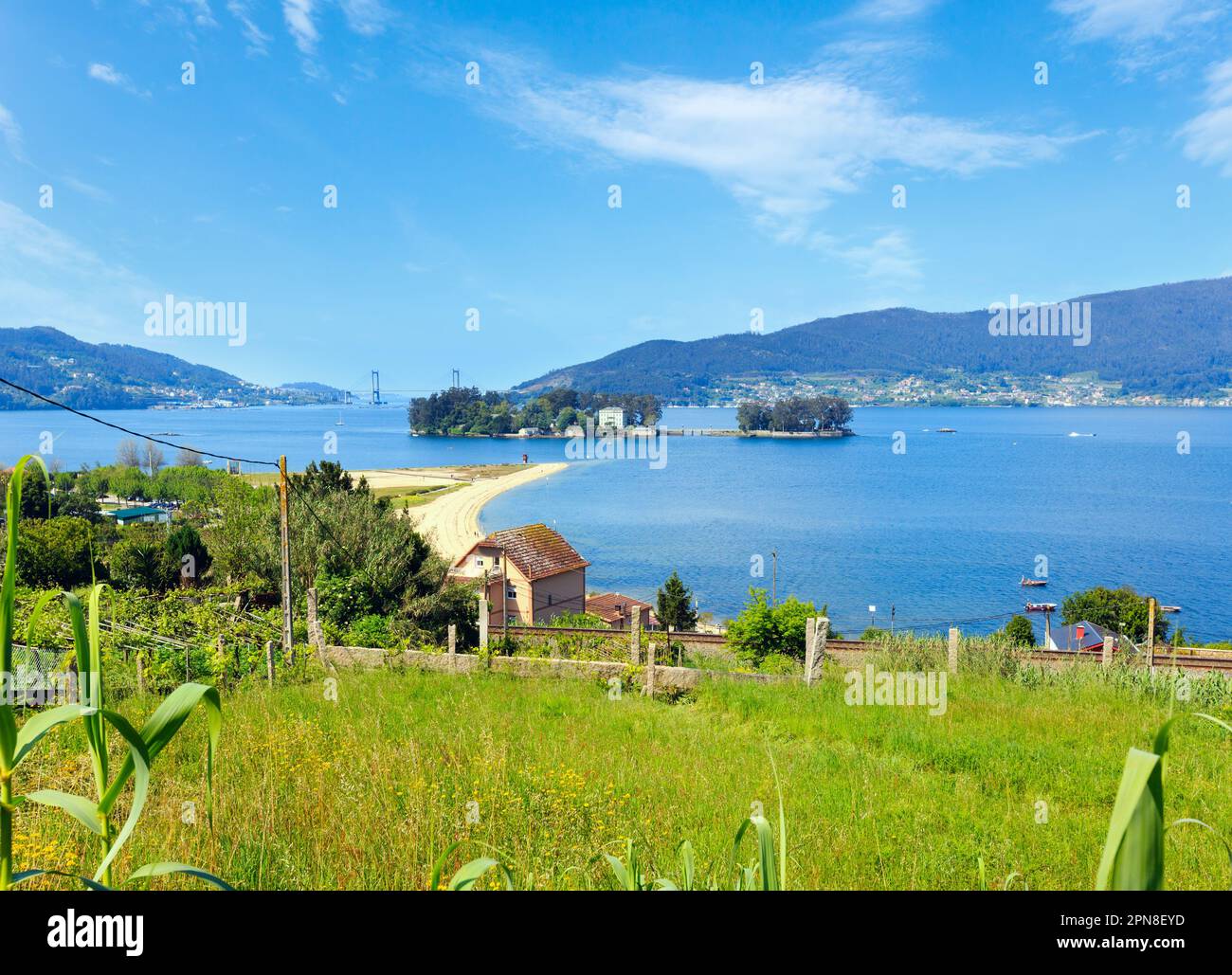 Sandy beach in Cesantes town and San Simon island (Galicia, Spain ...