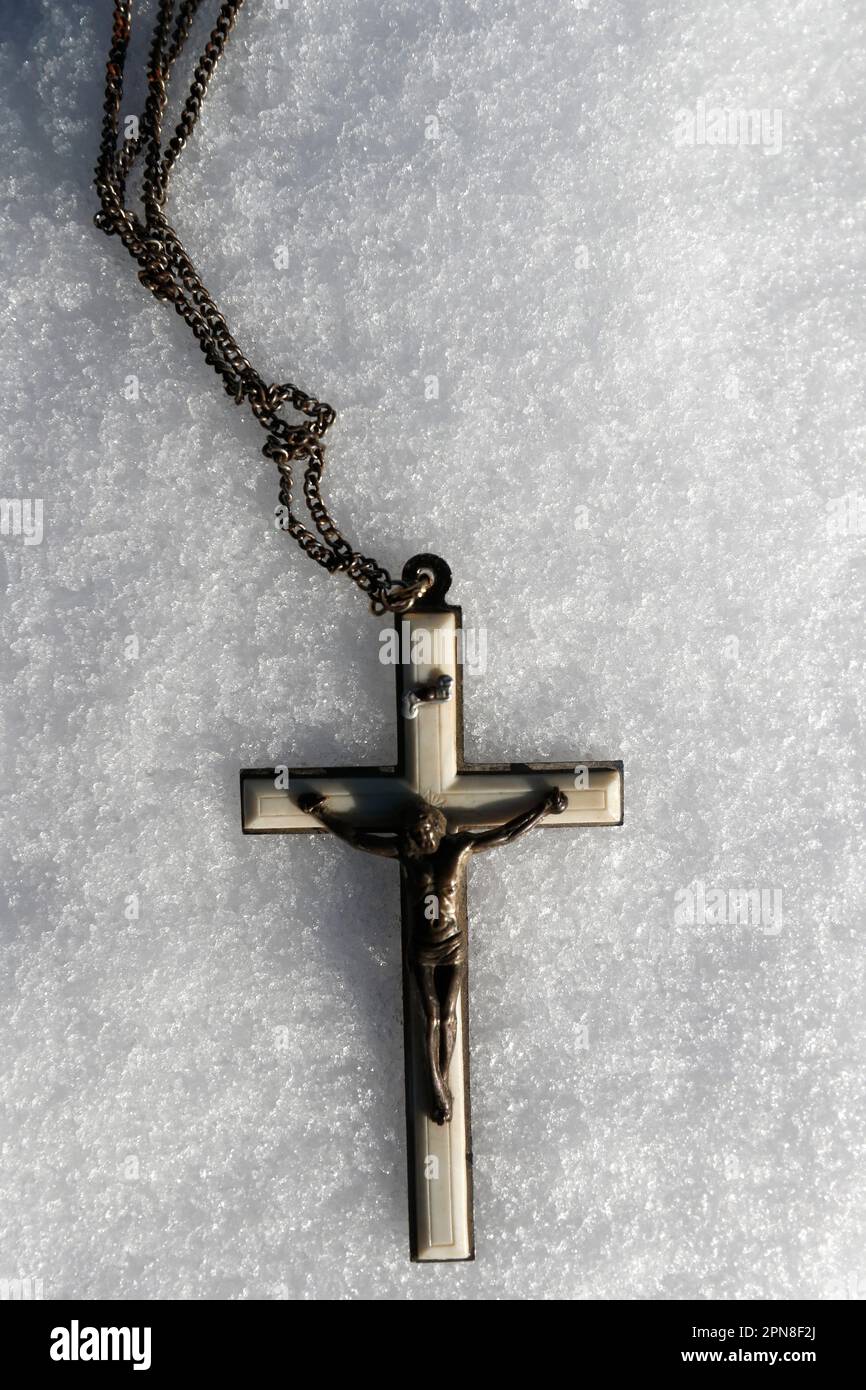 Old pendant in the snow with Jesus christ crucified. Crucifix Stock Photo - Alamy