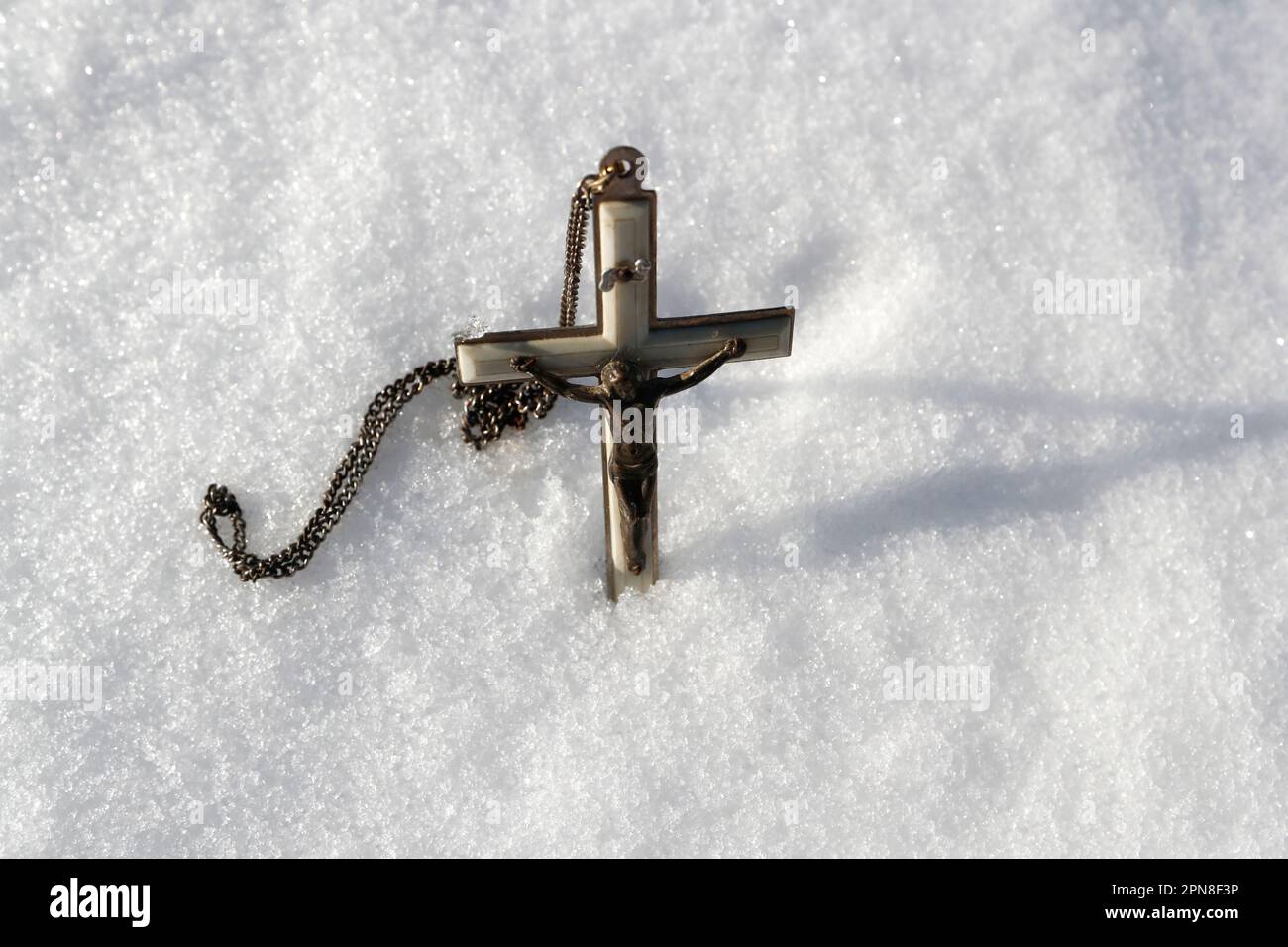 Old pendant in the snow with Jesus christ crucified. Crucifix Stock Photo - Alamy