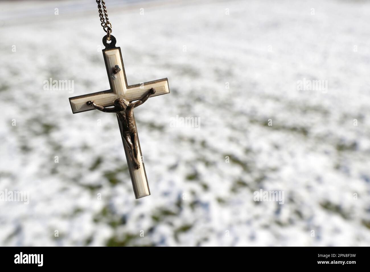 Old pendant in the snow with Jesus christ crucified. Crucifix Stock Photo - Alamy