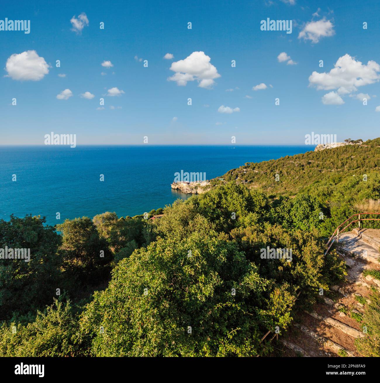 Summer sea perched Peschici town and cape Trabucco di Monte Pucci view ...