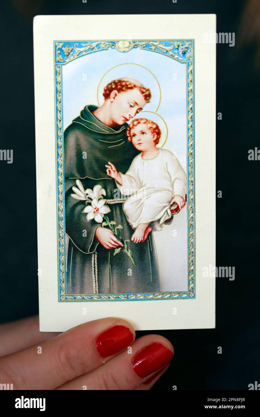 Catholic woman with holy image in hand. Saint Joseph with infant Jesus ...
