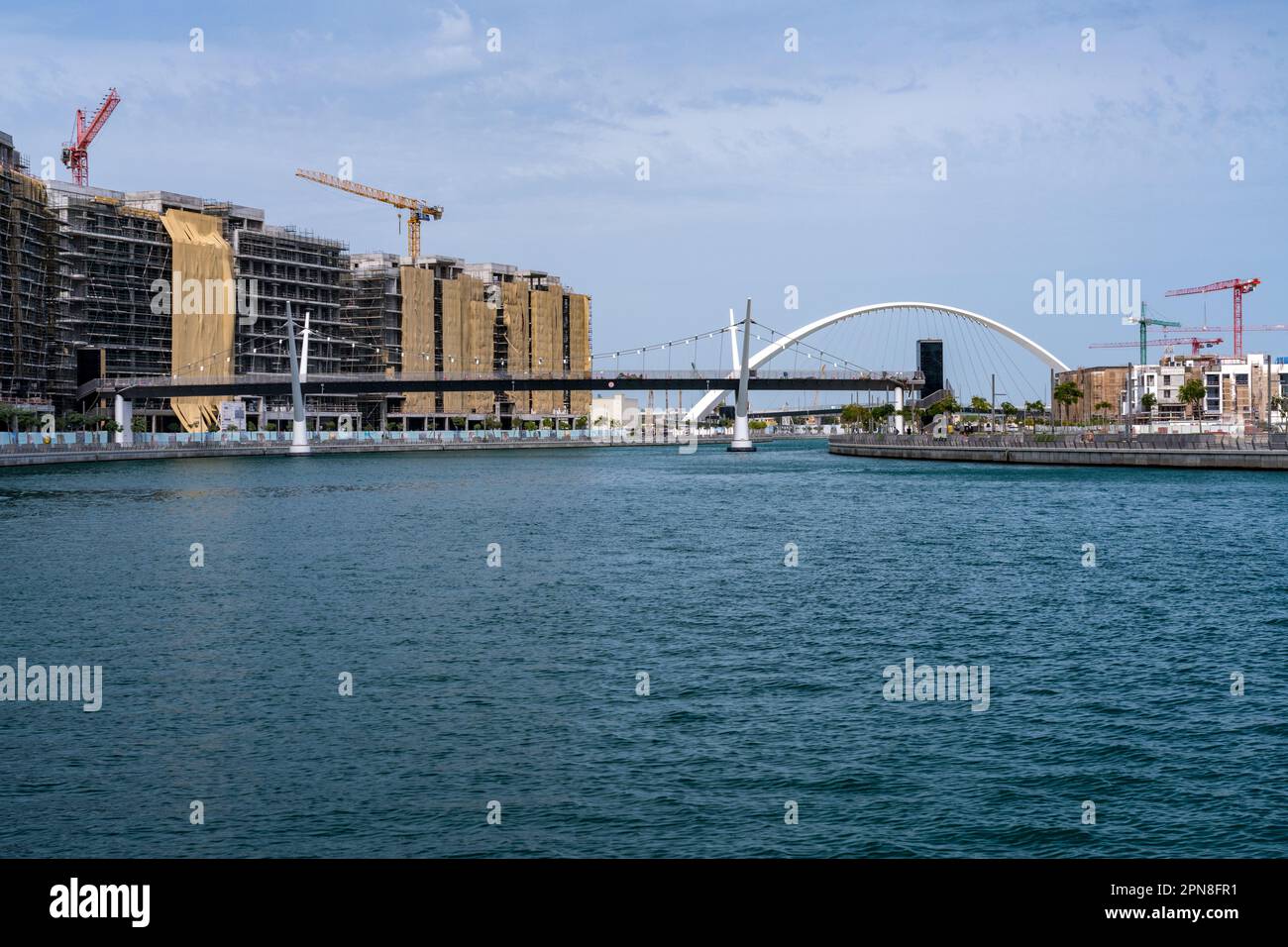 Cranes around new construction of apartments alongside the Dubai Canal ...