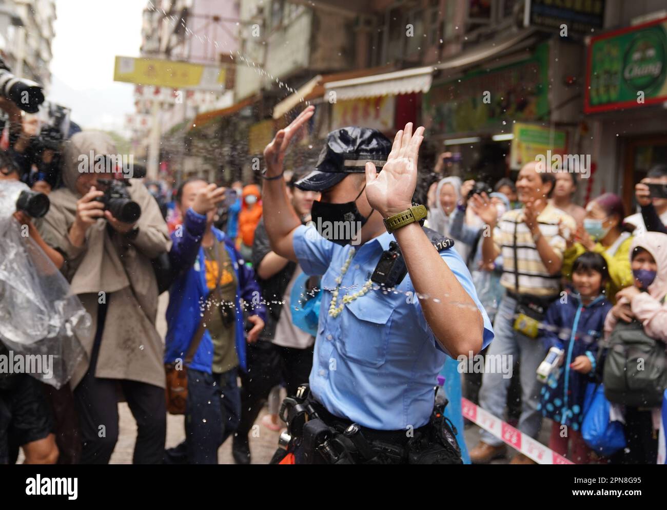 People splash water onto a police officer during Songkran Festival at ...