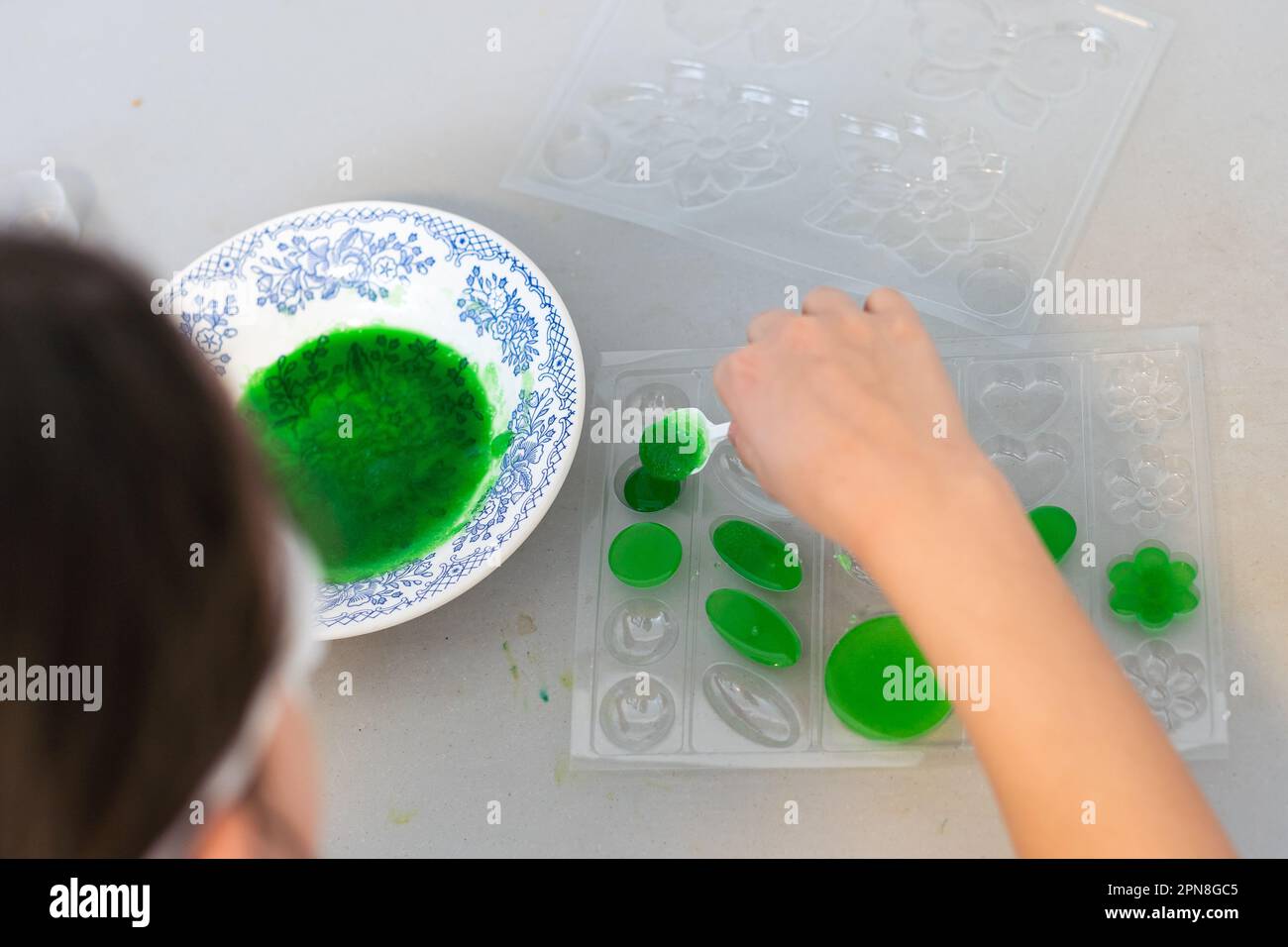 Enthusiastic little girl doing home science project, having a eureka ...