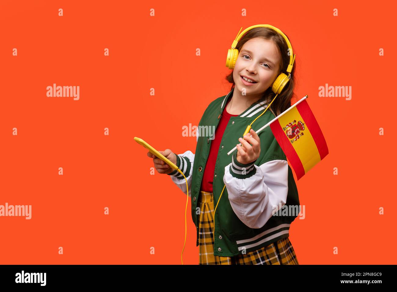 Teen school girl in casual clothes and headphones holds small national ...