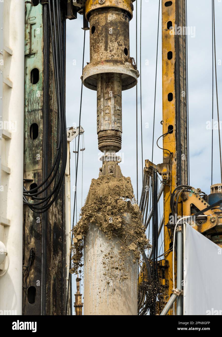 Dirt falling from auger or drill creating foundations for new ...