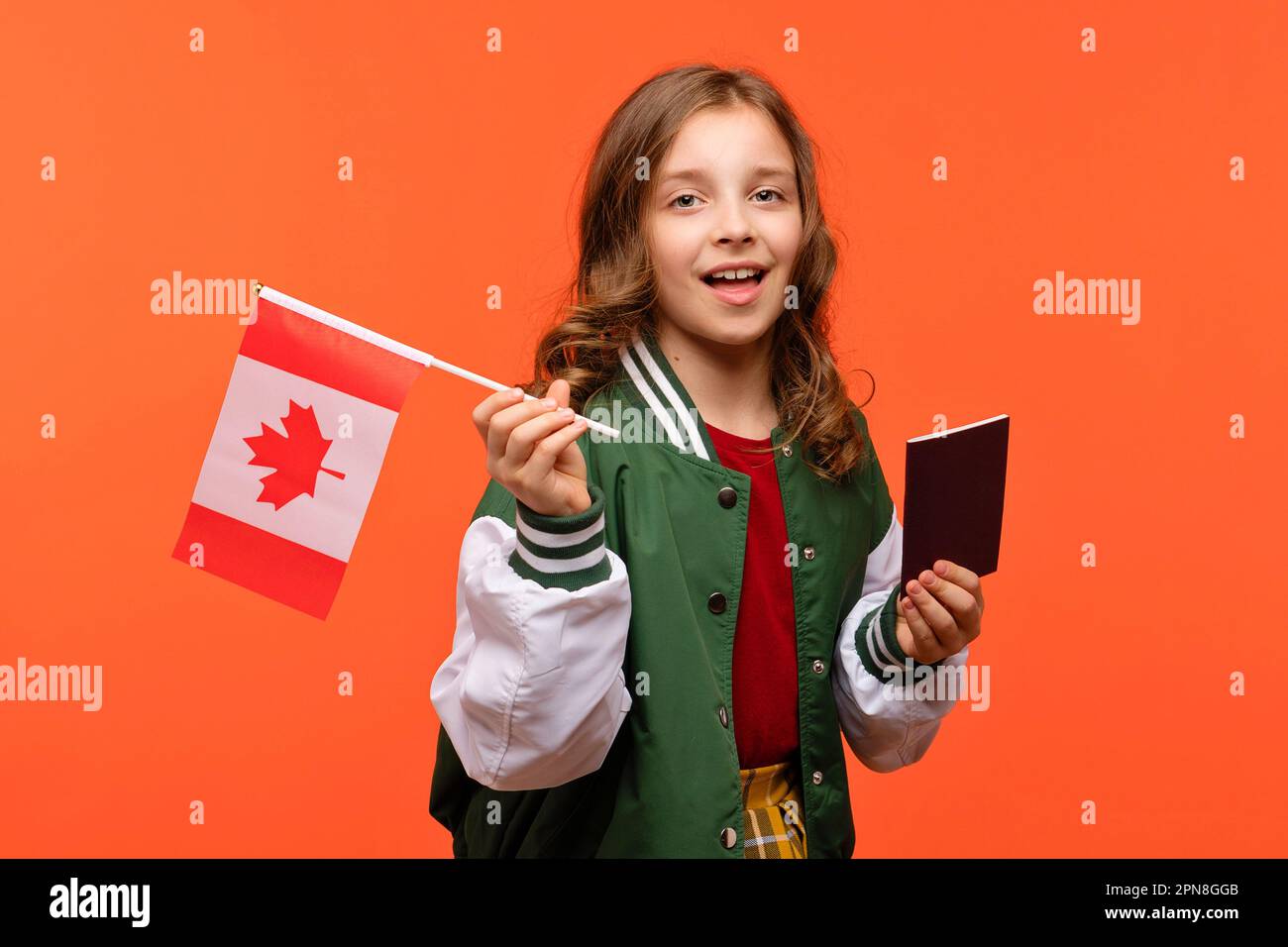 Girl wearing in school outfit and holds small national Flag of Canada ...