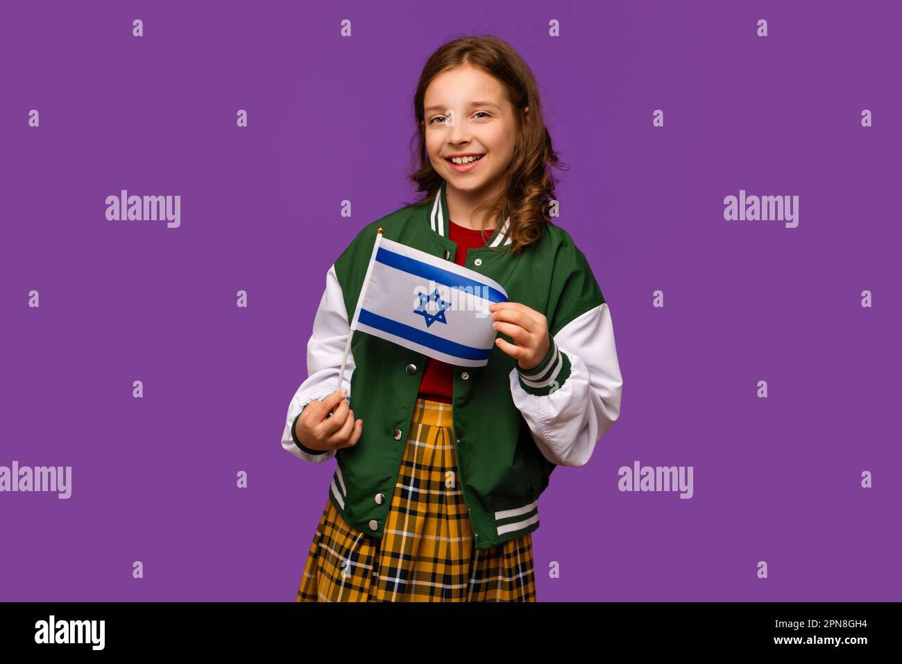 Girl wearing in school outfit and holds small national flag of the ...