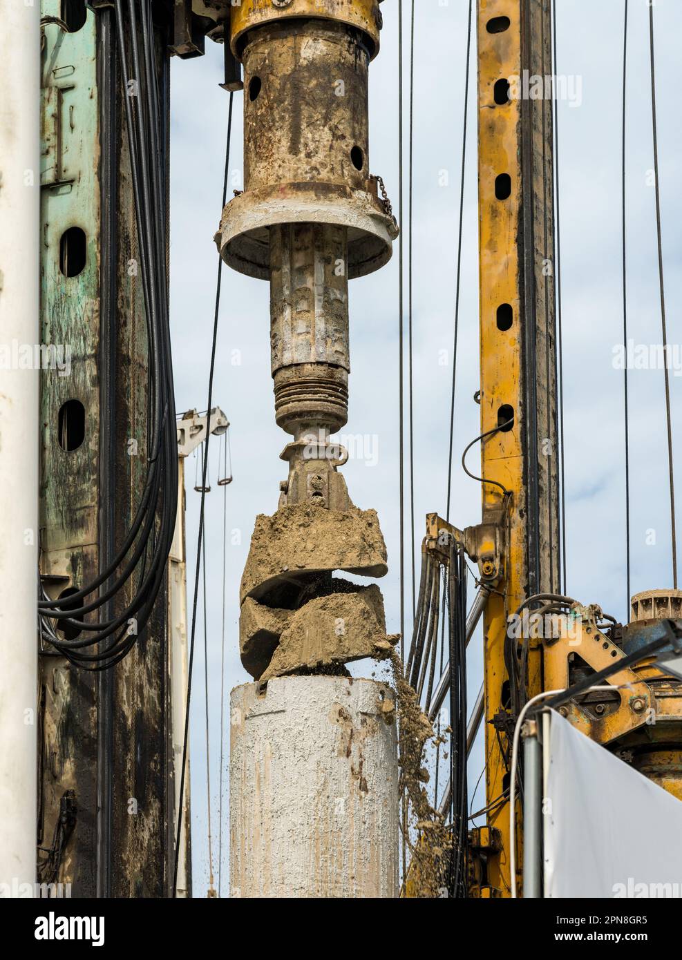 Dirt falling from auger or drill creating foundations for new ...