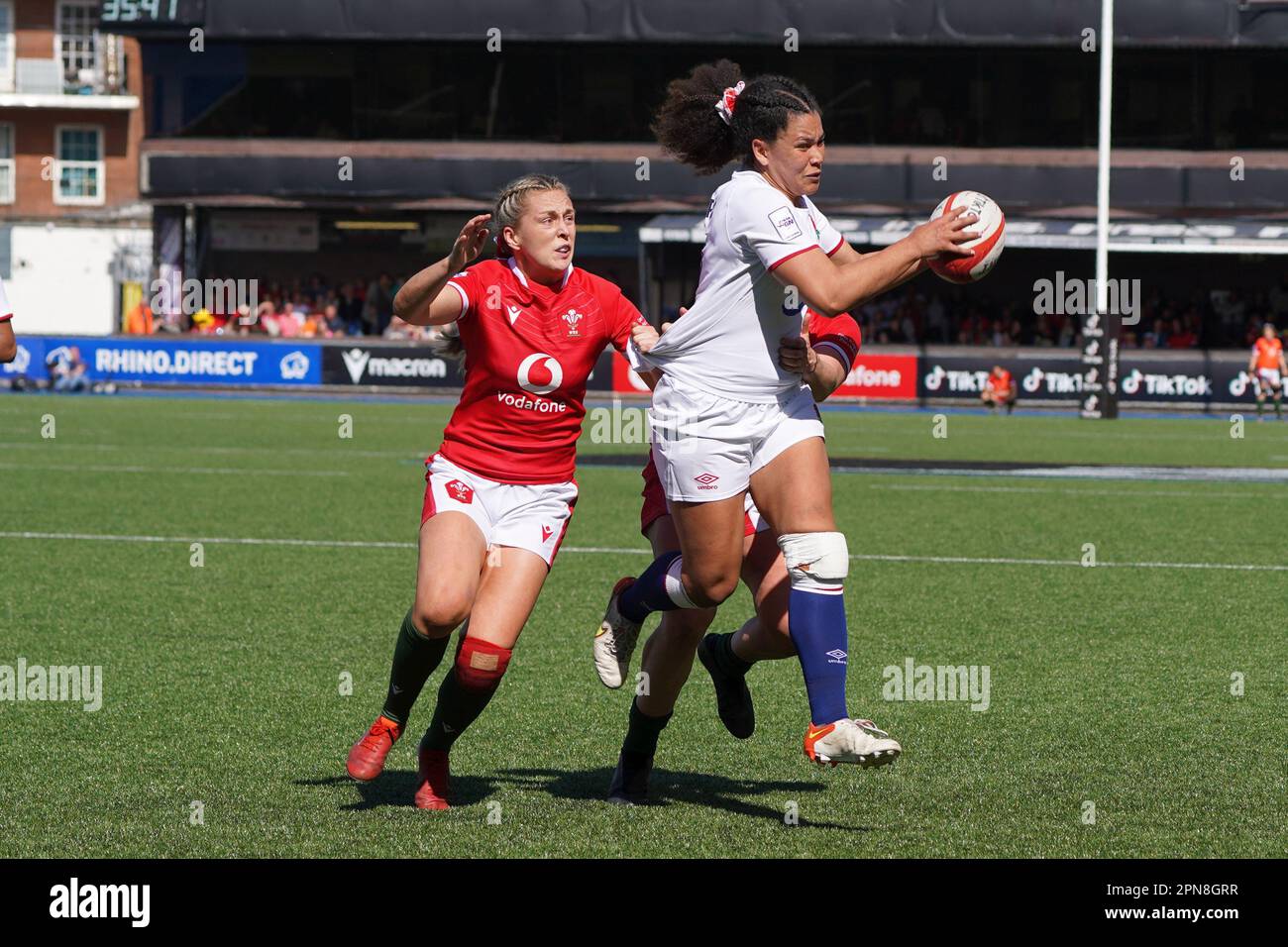 Tatyana Heard (England) slips the tackle of Hannah Jones (Wales) before ...