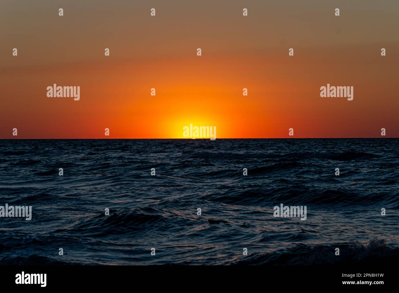 Gold sunrise on the beach Stock Photo - Alamy