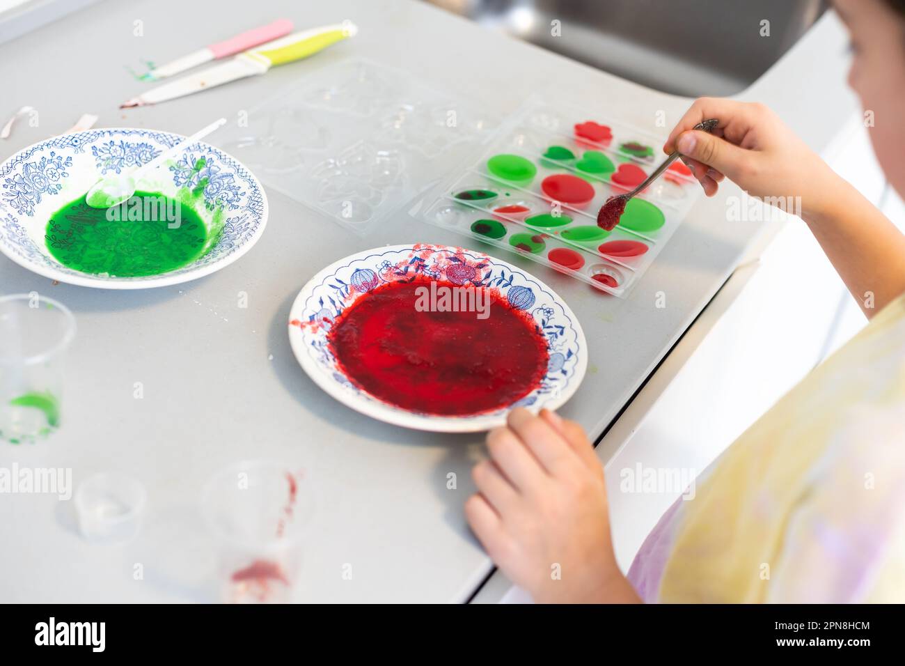 Enthusiastic little girl doing home science project, having a eureka ...