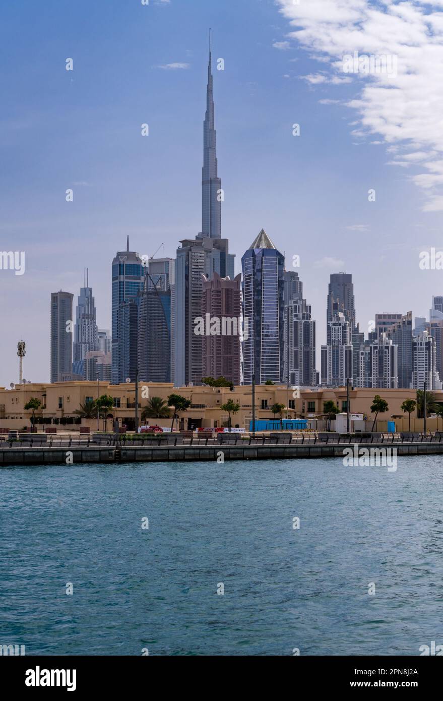 Low rise family homes alongside Dubai Canal with apartment blocks of ...