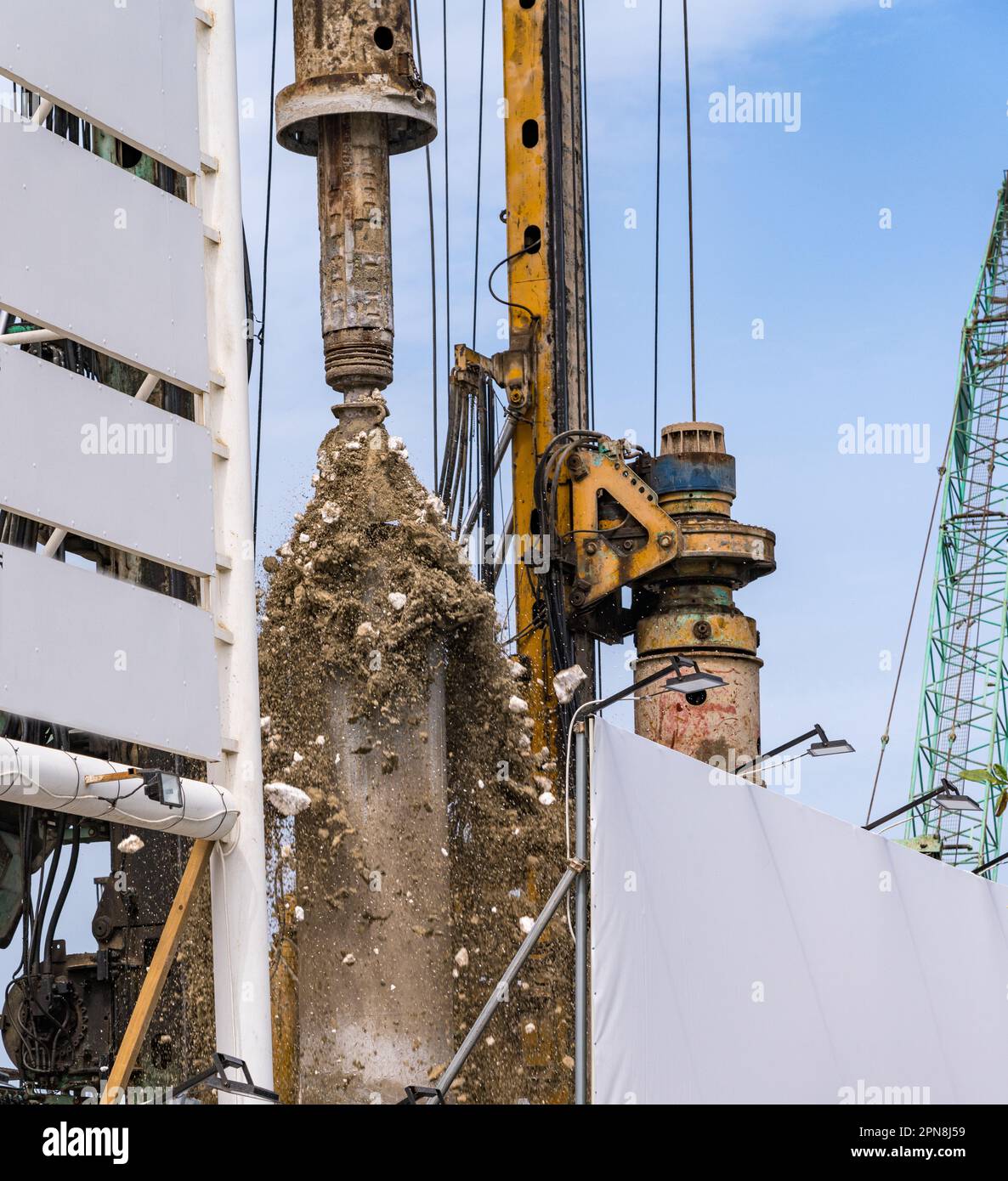 Dirt falling from auger or drill creating foundations for new ...