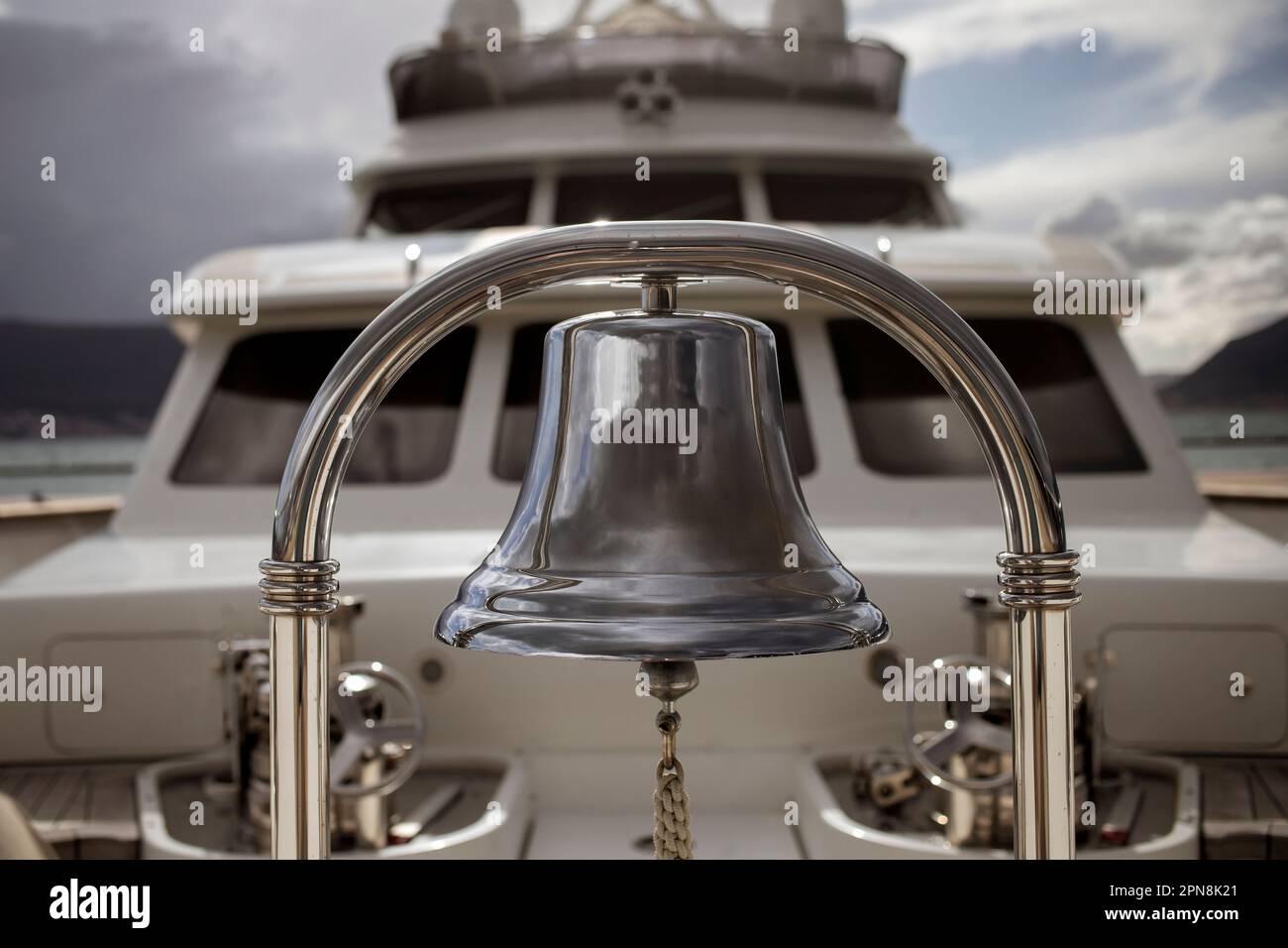 Ship bell mounted on board of a luxury motor yacht Stock Photo - Alamy