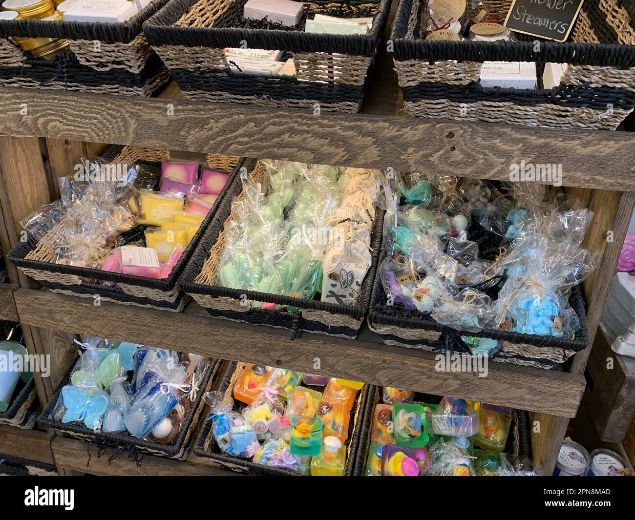 This photo shows a variety of colorful bar soaps on display in a store ...