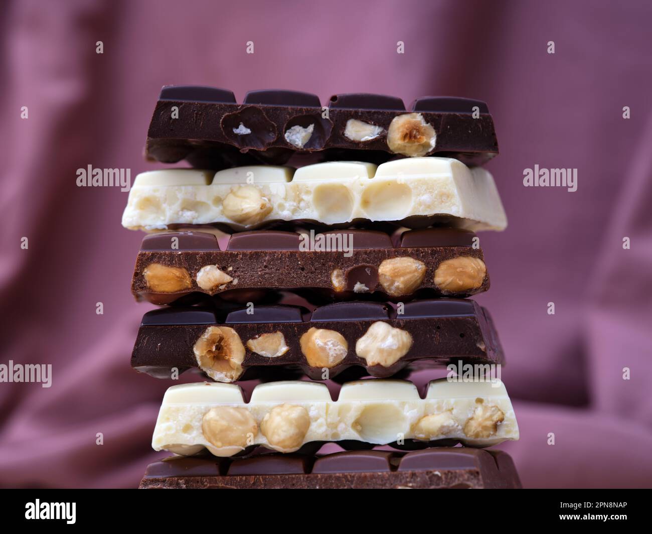 Stack of half chocolate bars with hazelnuts - milk chocolate, dark ...
