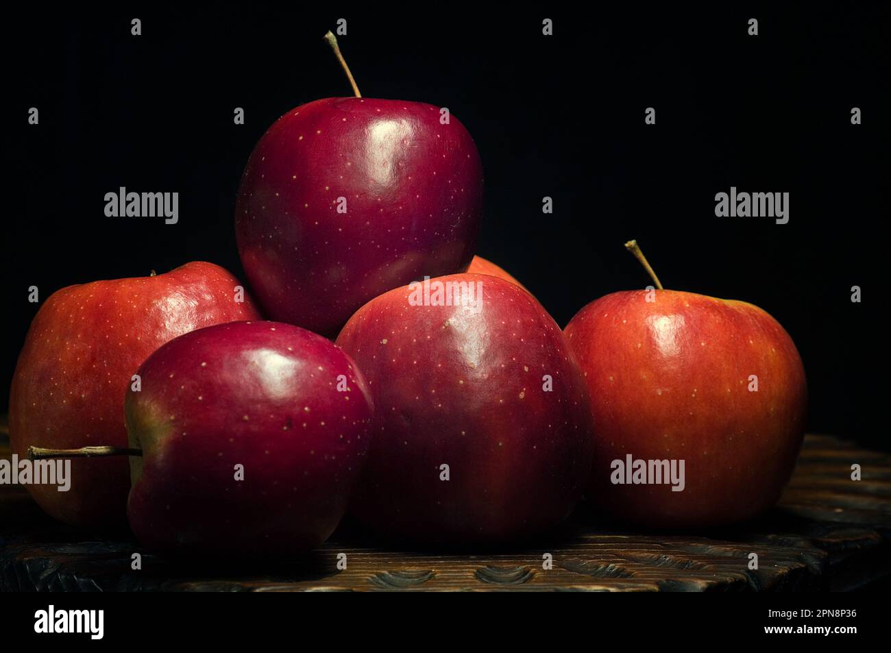Very sweet and ecological red apples on a black background collected on ...