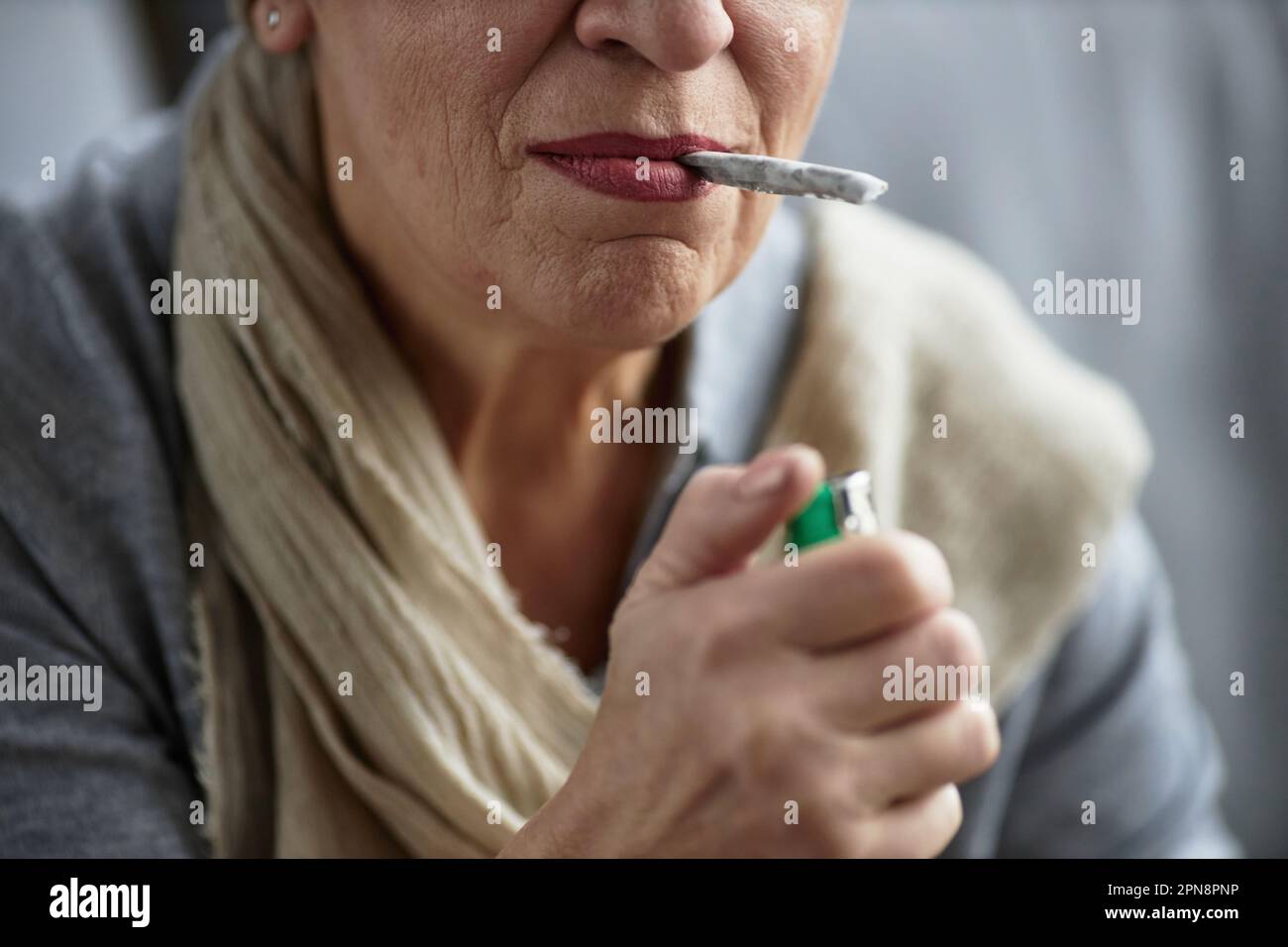 Closeup of adult woman lighting up cigarette smoking for therapeutic ...