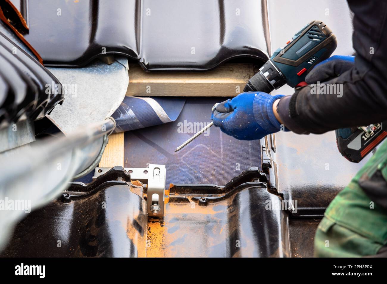 Installation of a bracket for a solar panel substructure on a roof ...