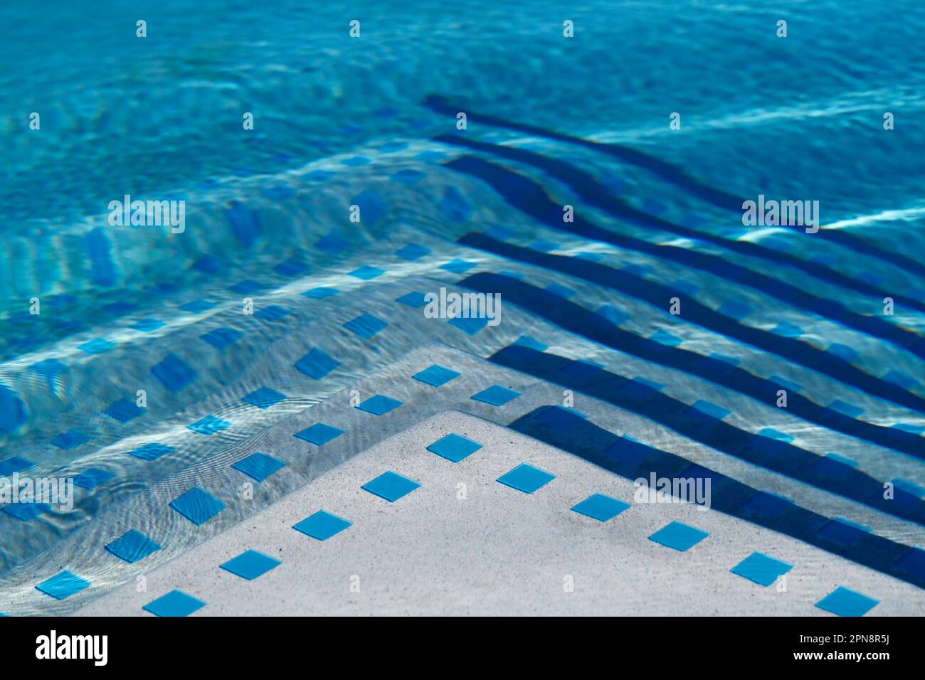Abstract swimming pool image blue water, tiles and stairs. Cayman ...