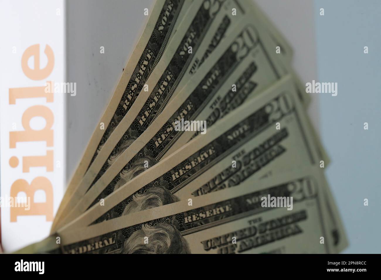 Money and religion. Banknotes of US dollars with Holy Bible. Christian ...