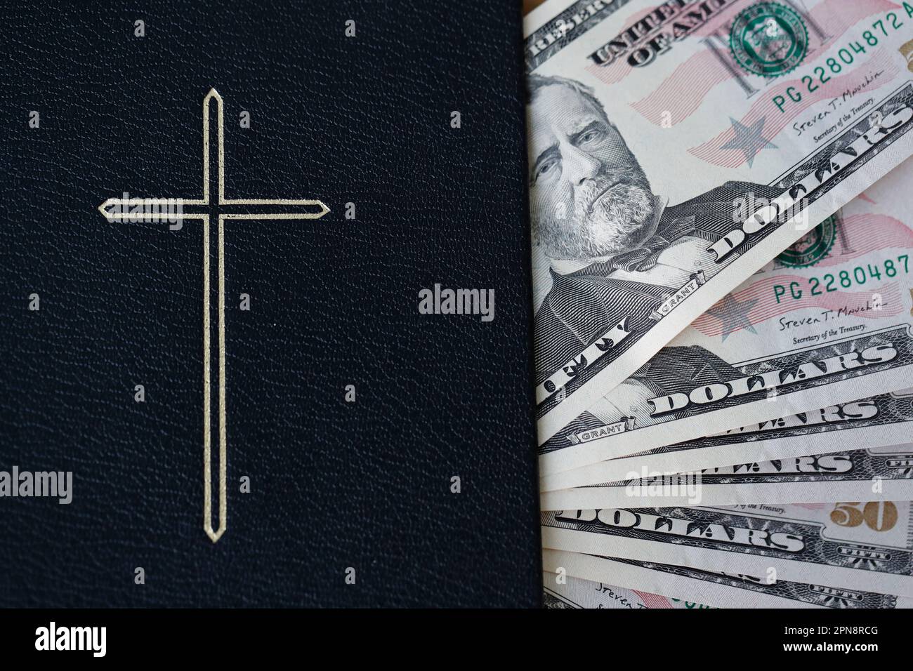 Money and religion. Banknotes of US dollars with Holy Bible. Christian ...