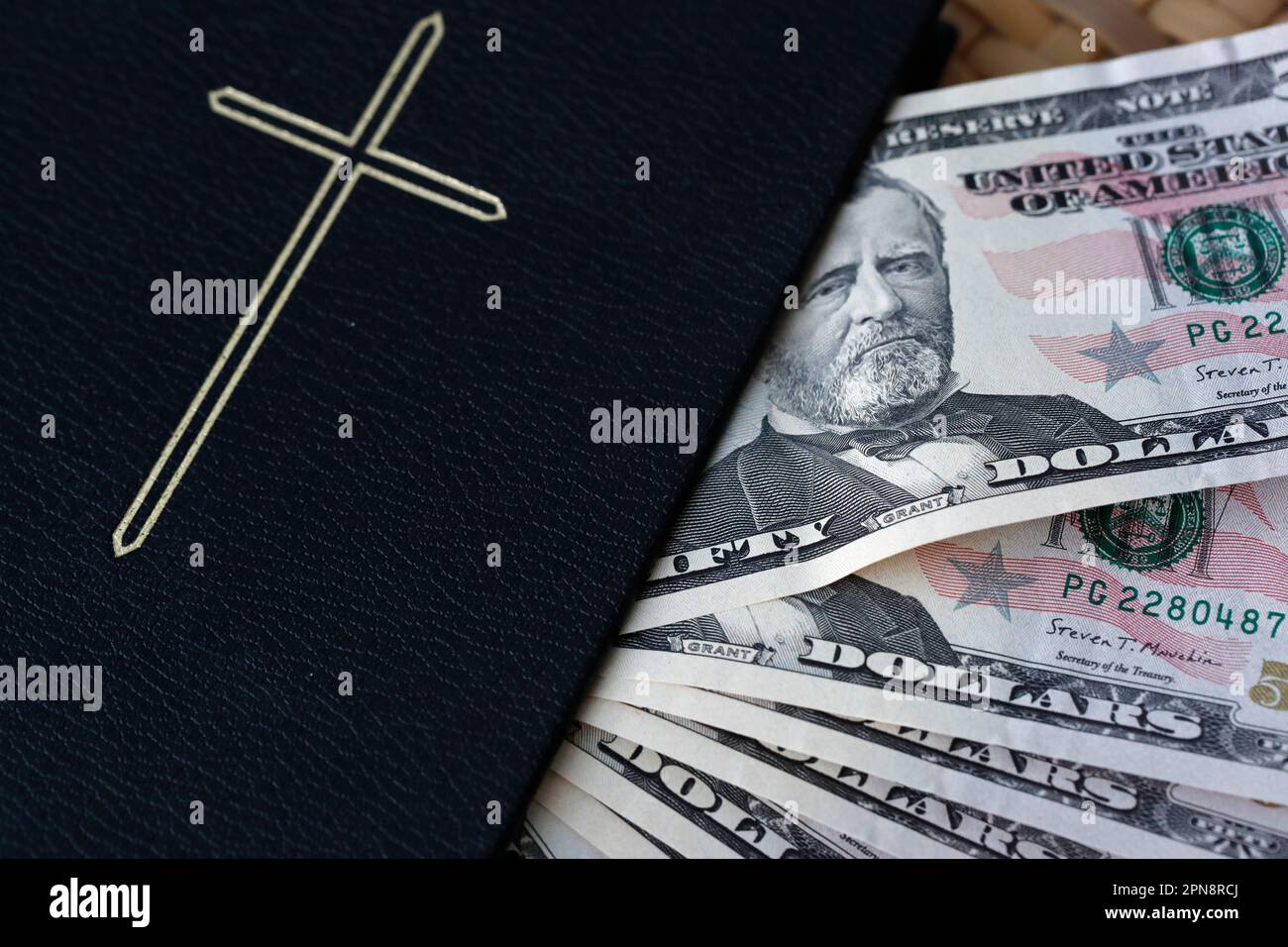Money and religion. Banknotes of US dollars with Holy Bible. Christian ...