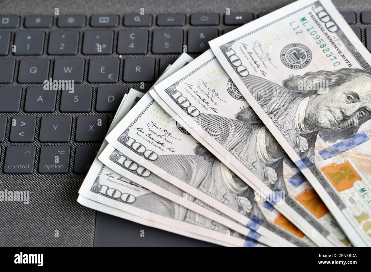 Money and religion. Banknotes of US dollars with rosary on a laptop ...