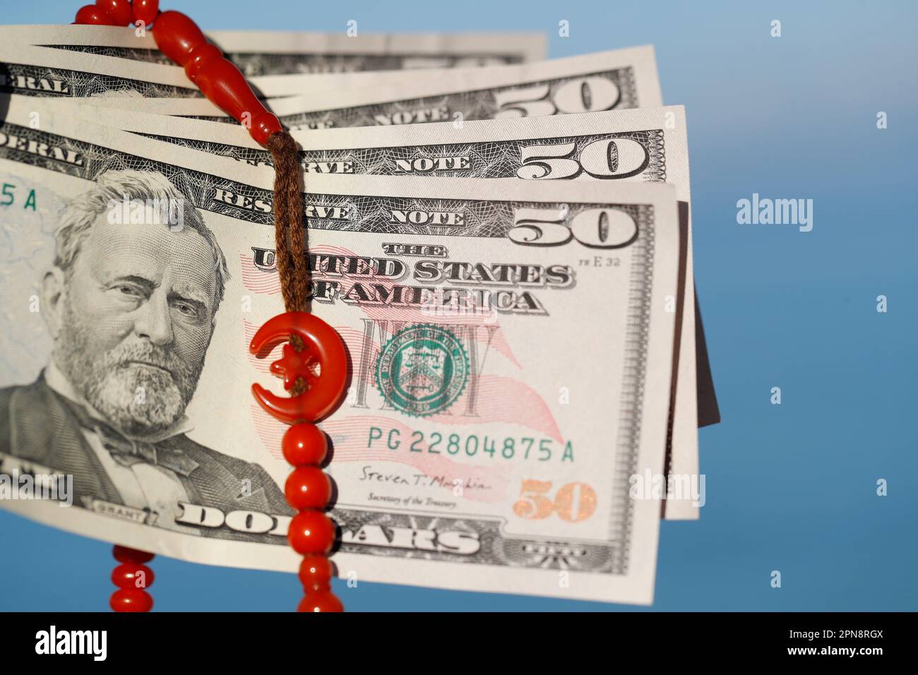 Money and religion. Banknotes of US dollars with Holy Quran book ...