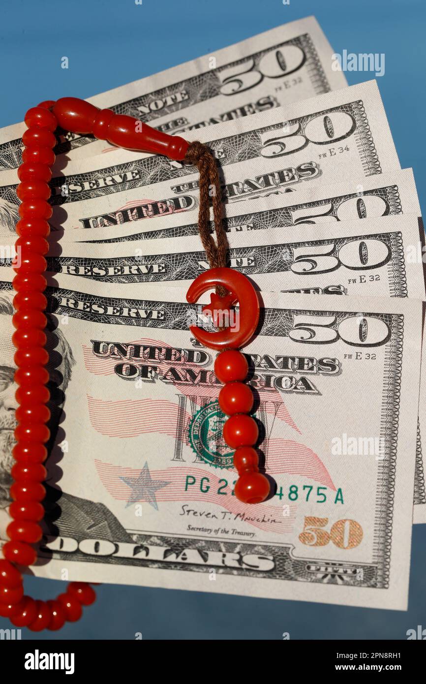 Money and religion. Banknotes of US dollars with Holy Quran book ...