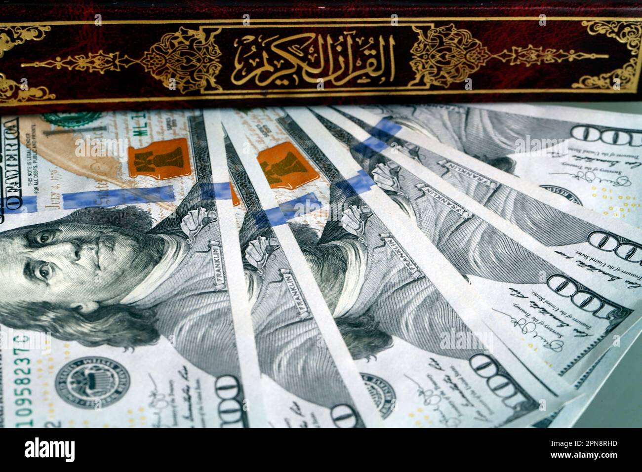 Money and religion. Banknotes of US dollars with Holy Quran book ...