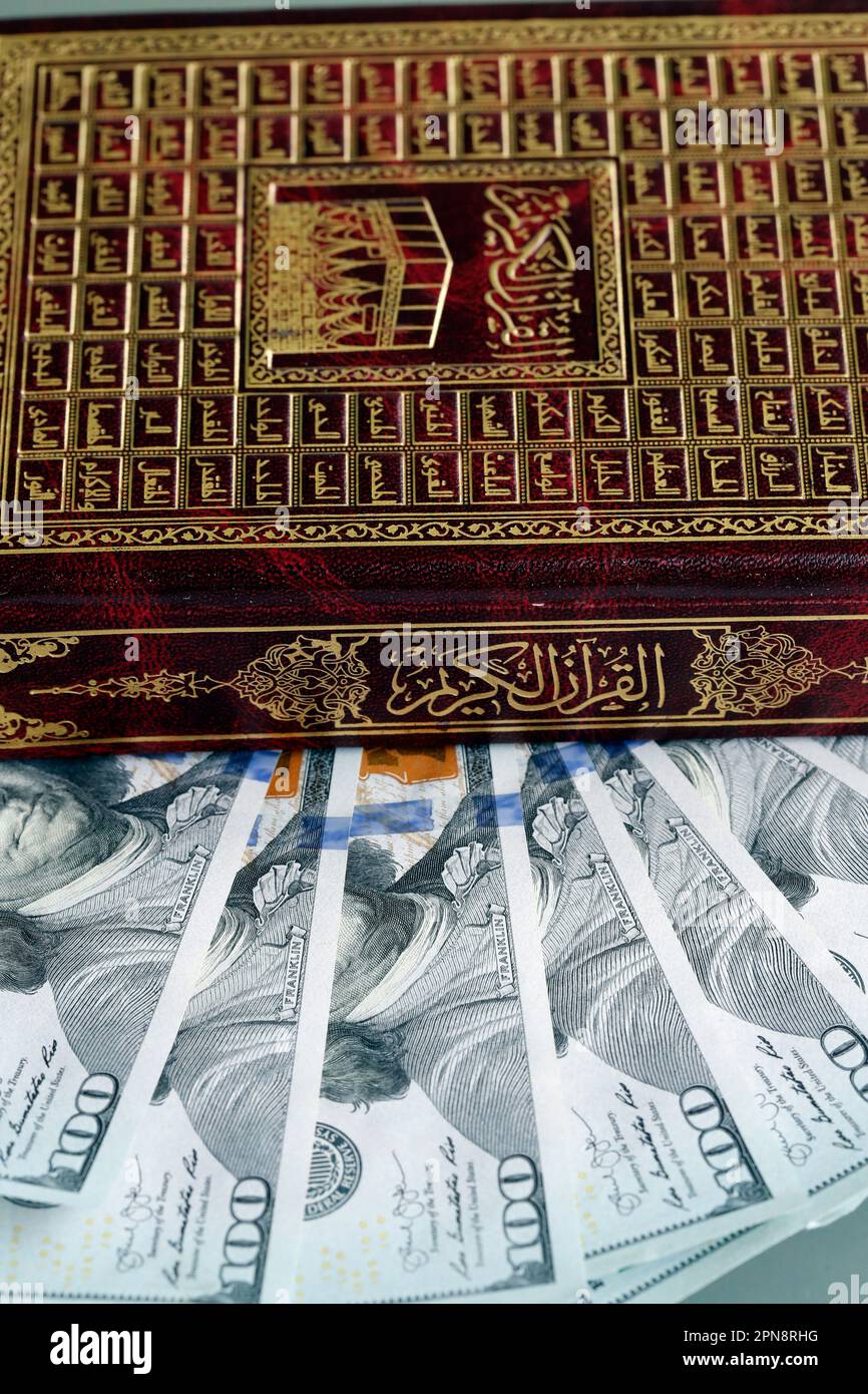 Money and religion. Banknotes of US dollars with Holy Quran book ...