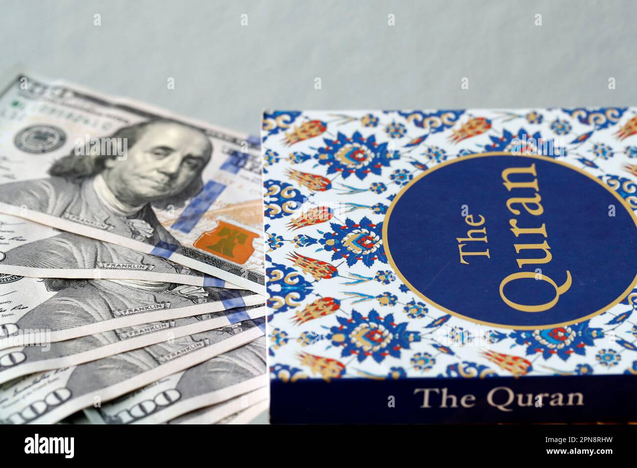Money and religion. Banknotes of US dollars with Holy Quran book ...
