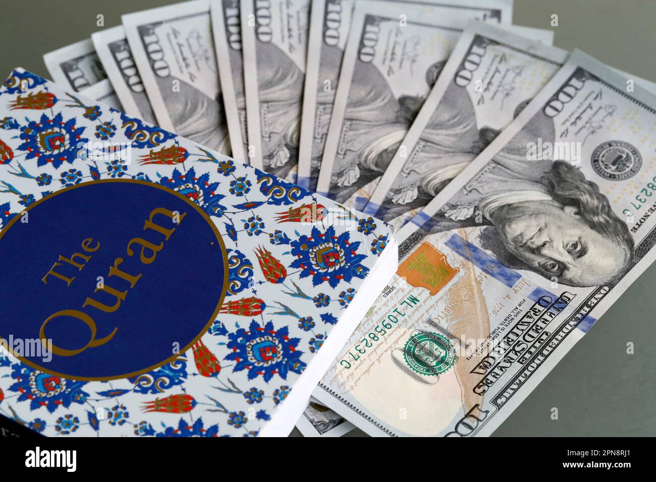 Money and religion. Banknotes of US dollars with Holy Quran book ...